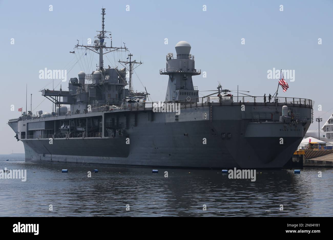 U.S. troopers stand beside the U.S. flag on the USS Blue Ridge (LCC-19 ...