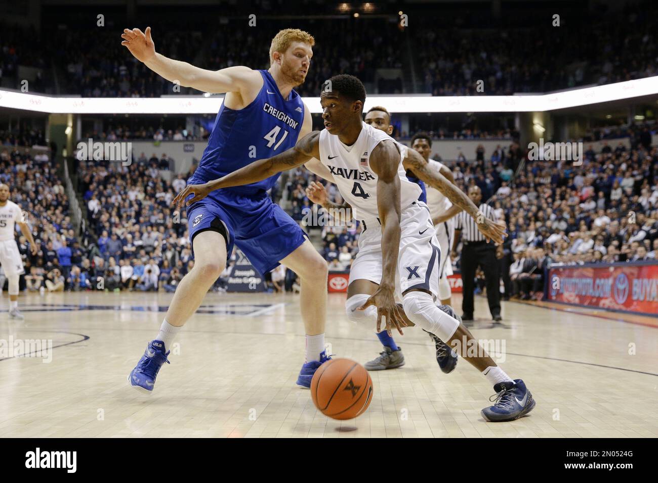 Creighton's Ronnie Harrell Jr. (4) drives past Creighton's Geoffrey ...
