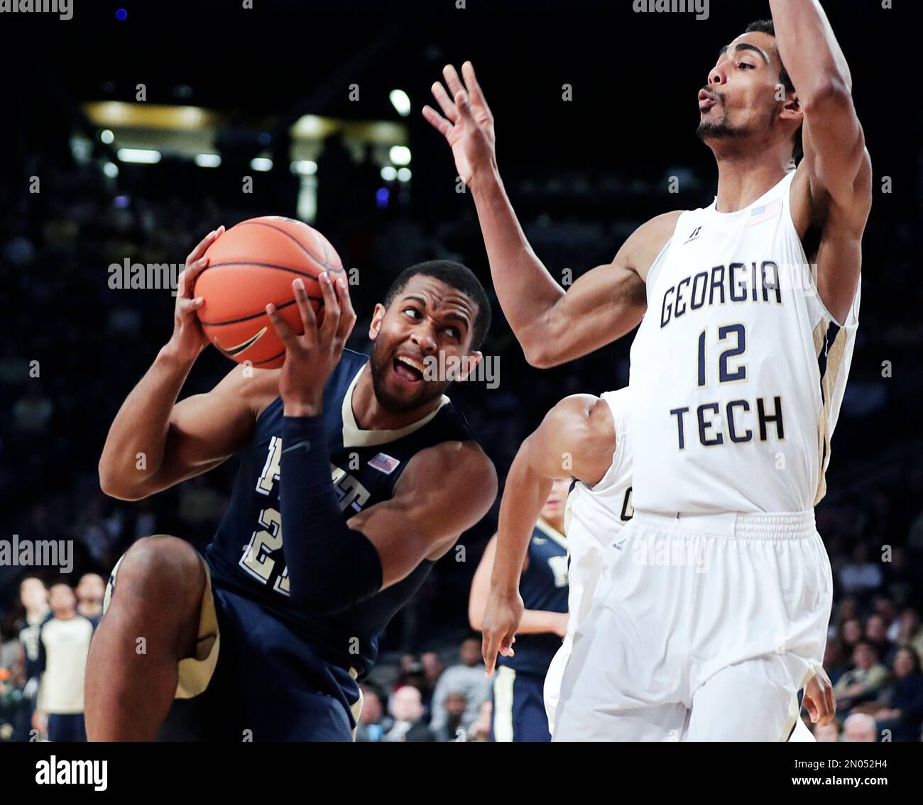 Pittsburgh's Sheldon Jeter, left, puts up a shot against Georgia Tech's ...