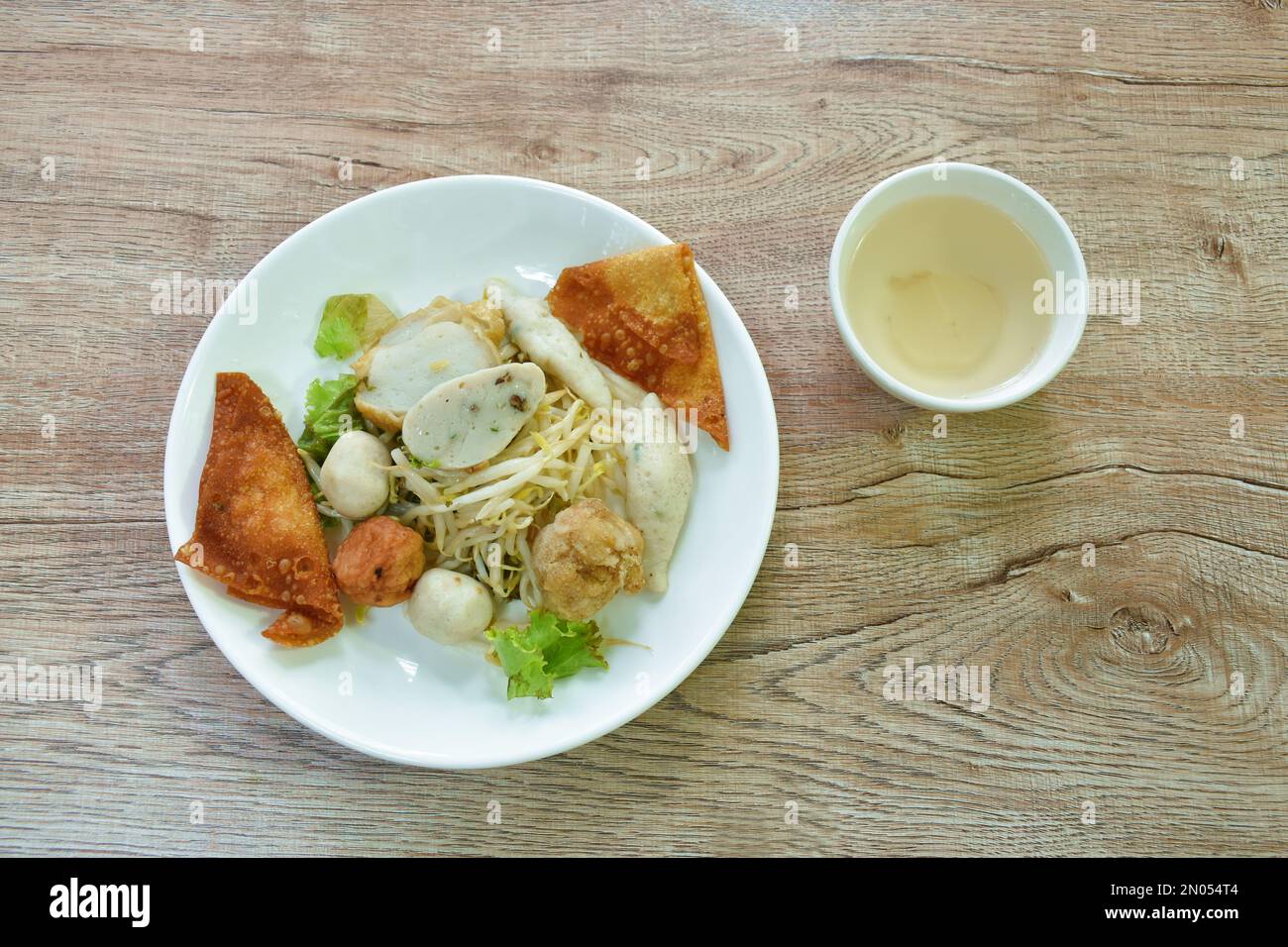 boiled fish and shrimp ball with bean sprout on plate with radish soup ...