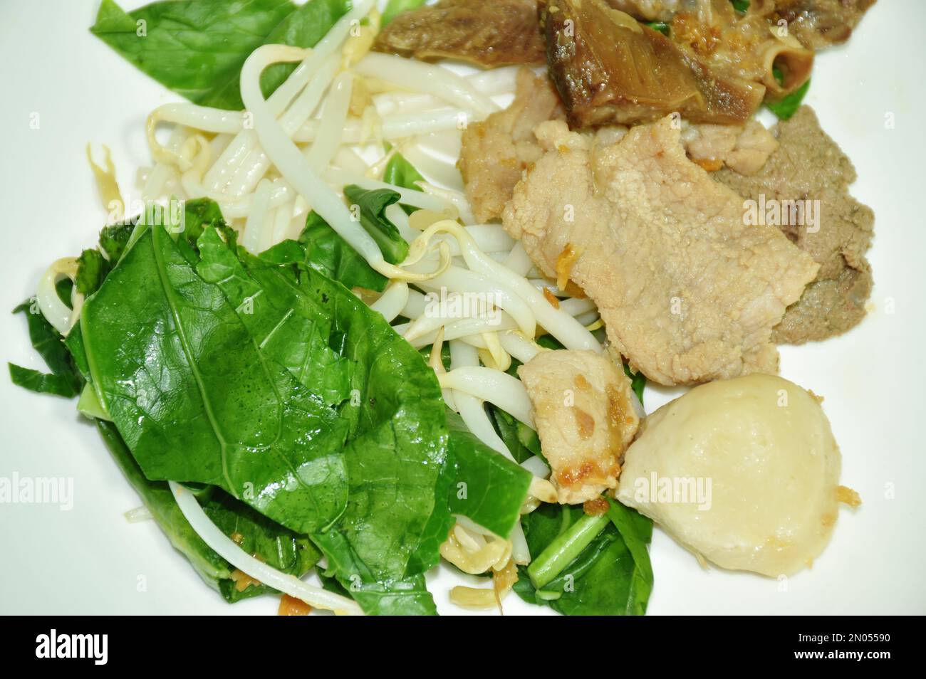 boiled slice braised beef and meatball on plate dipping spicy and sour ...