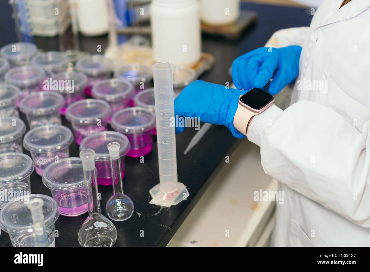 woman in a lab coat using a smartwatch in the lab Stock Photo - Alamy