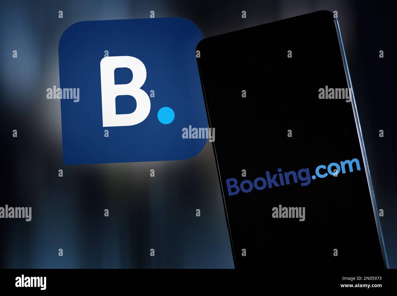 Booking logo on smartphone display and background. Travel concept ...