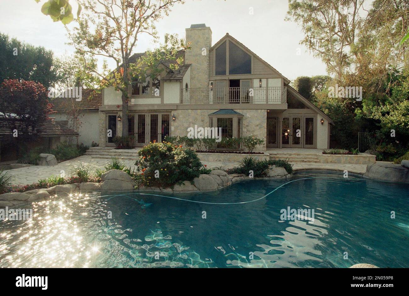 FILE: O.J. Simpson's former estate and pool are shown from the backyard ...