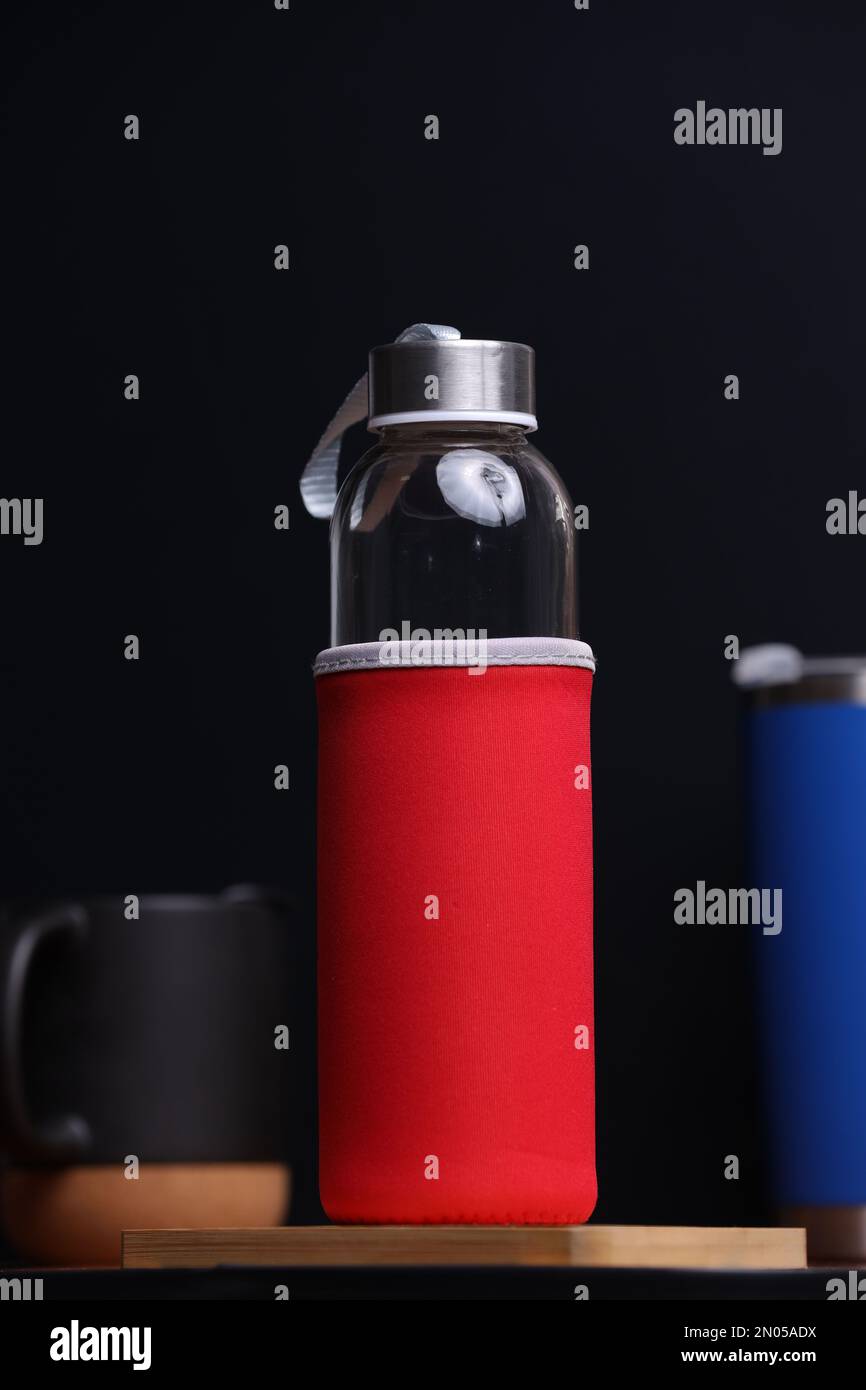 Glass Water Bottle With Red Color Pouch And Metal Cap Stock Image And Black Background Stock