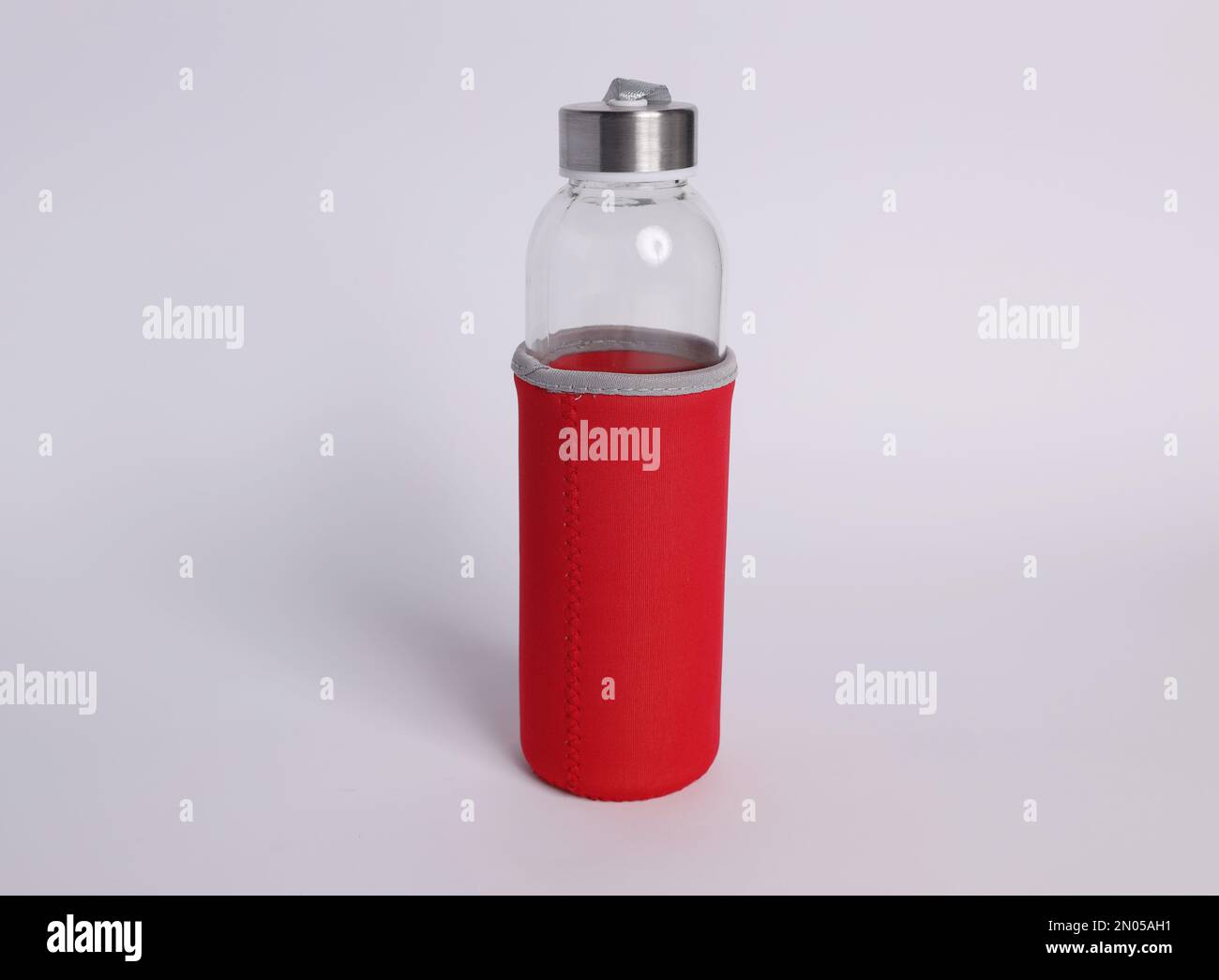 glass water bottle with red color pouch and metal cap stock image Stock ...
