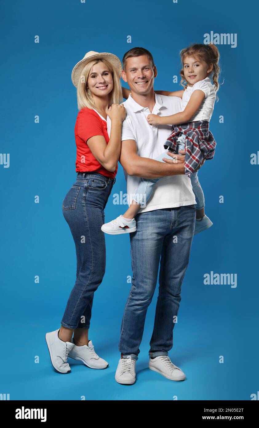 Happy family with child on blue background Stock Photo - Alamy