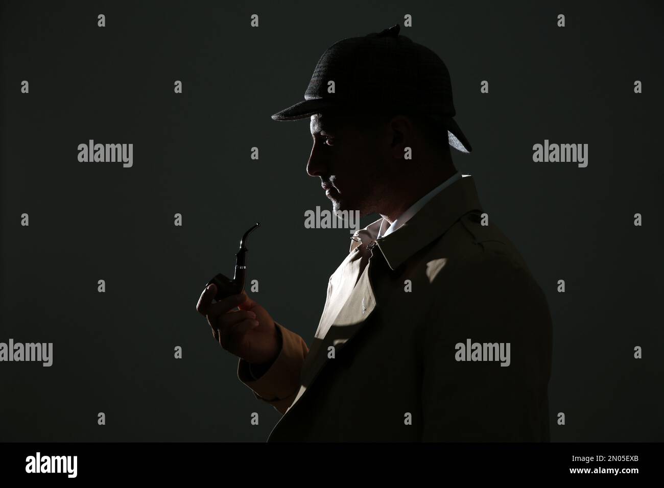 Old fashioned detective with smoking pipe on dark background Stock ...