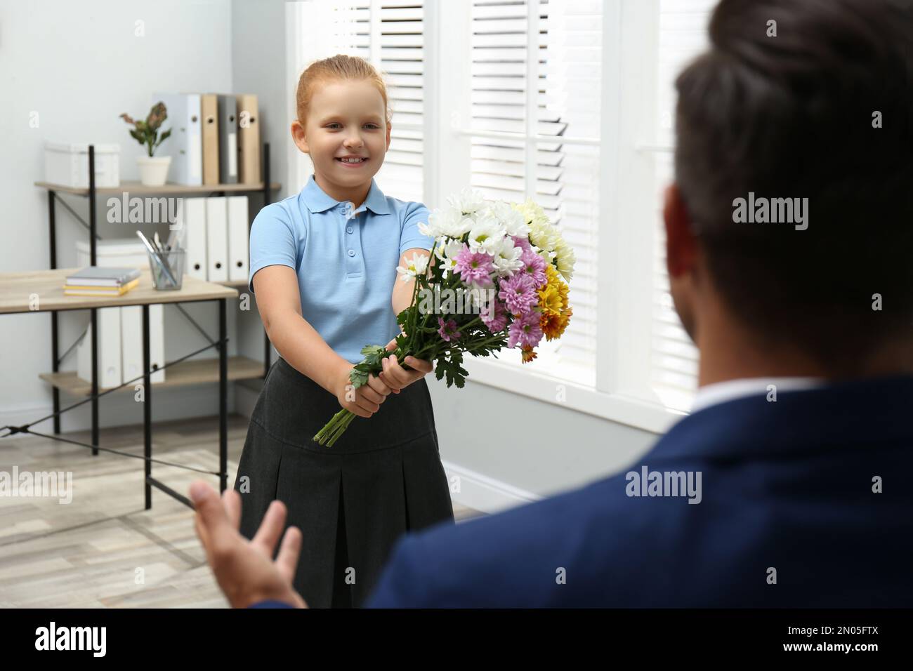 Child giving present to teacher hi-res stock photography and images - Alamy