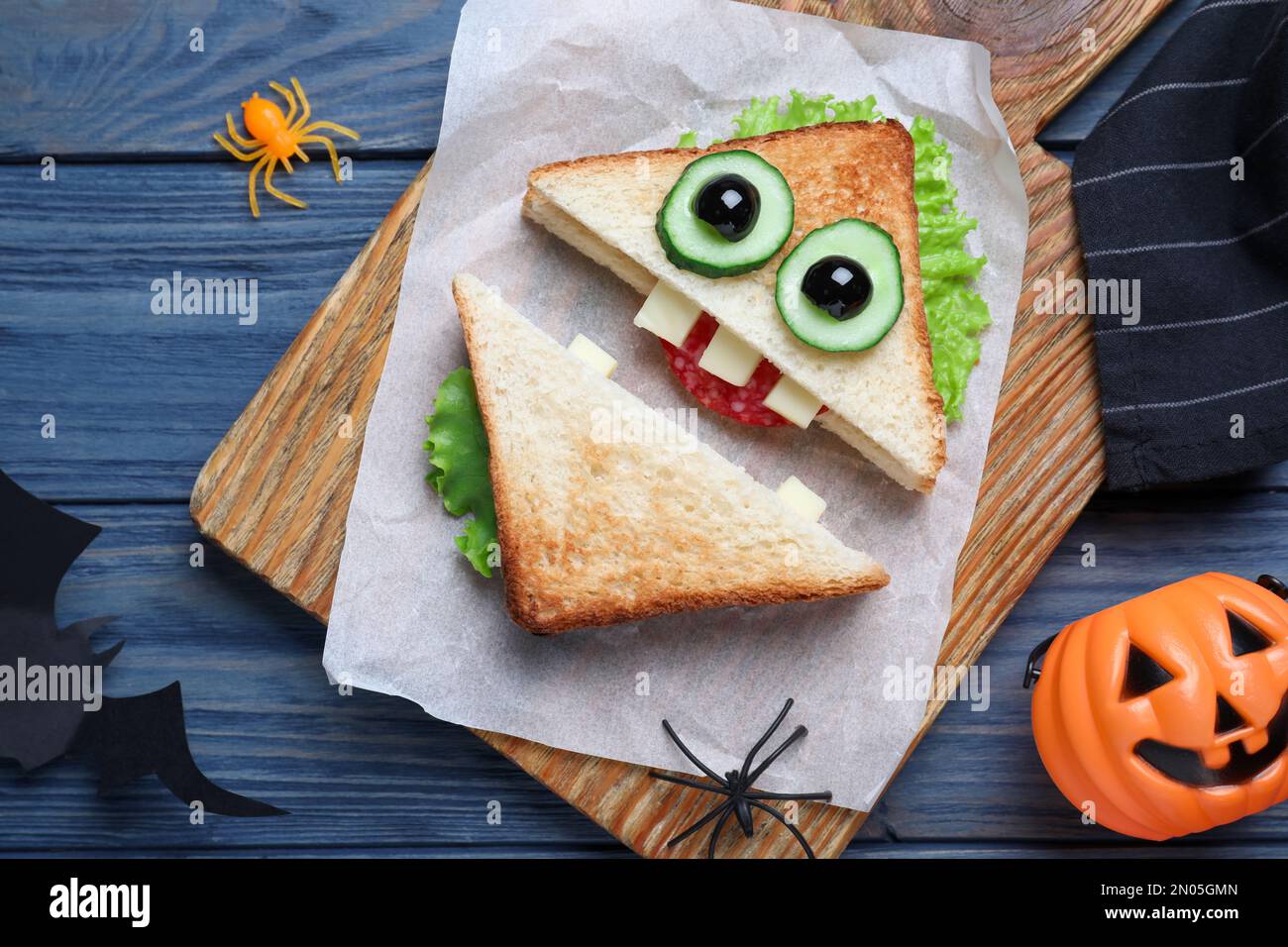 Cute monster sandwich served on blue wooden table, flat lay. Halloween ...