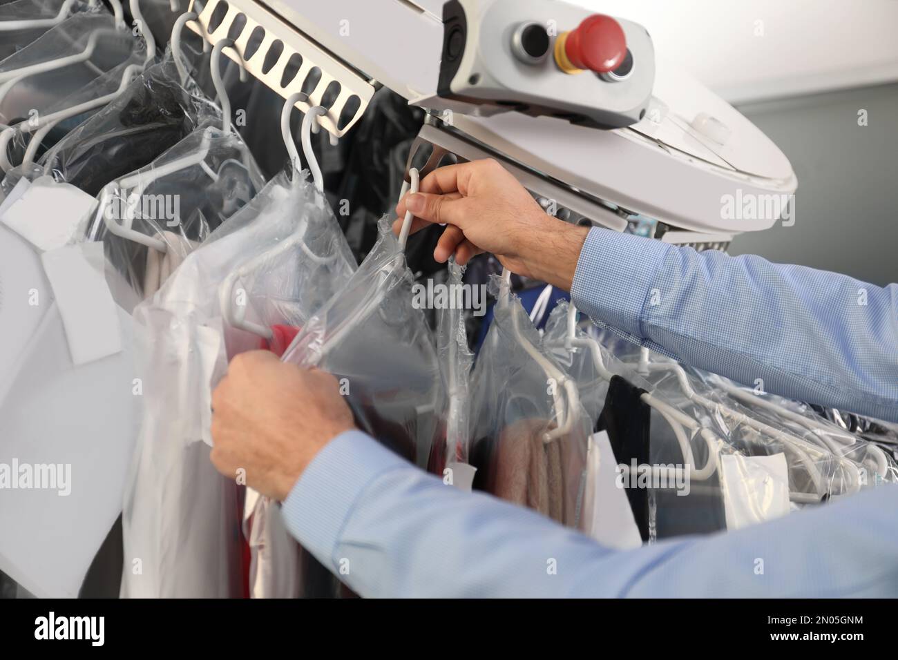 Man taking shirt from hanger hi-res stock photography and images - Alamy
