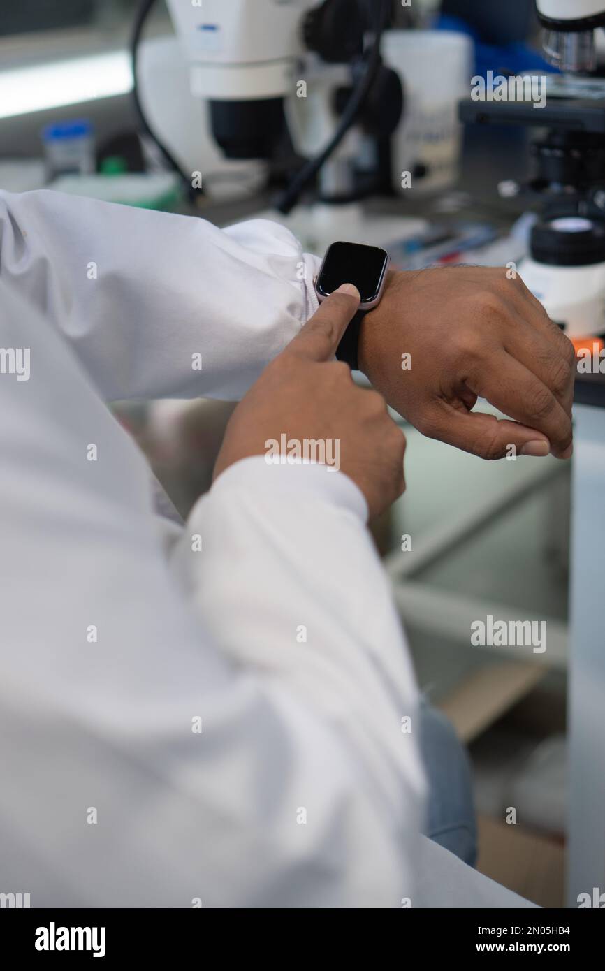 Close-up of a scientist using a smartwatch in the lab Stock Photo - Alamy