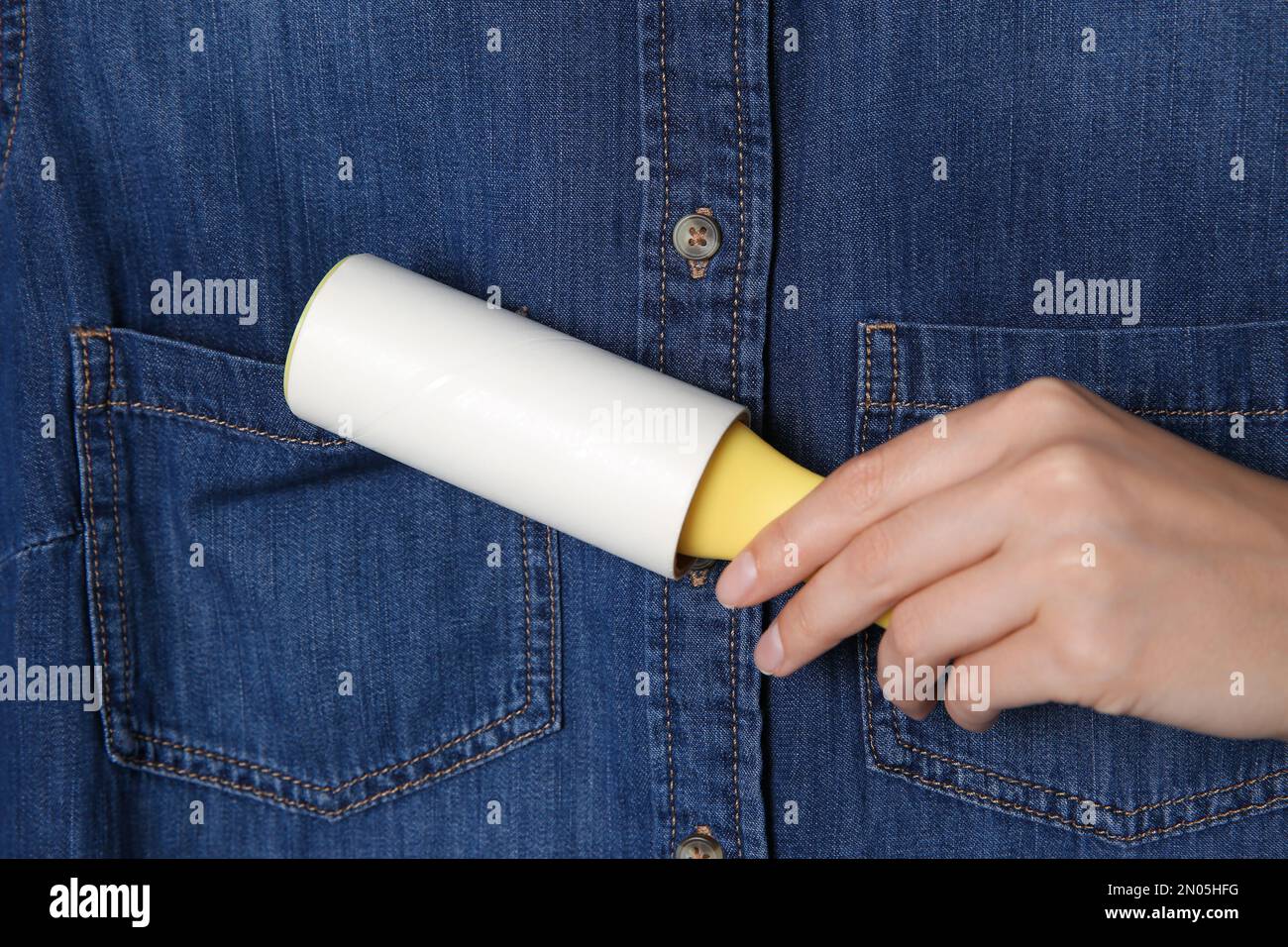Woman cleaning lint roller hi-res stock photography and images - Alamy