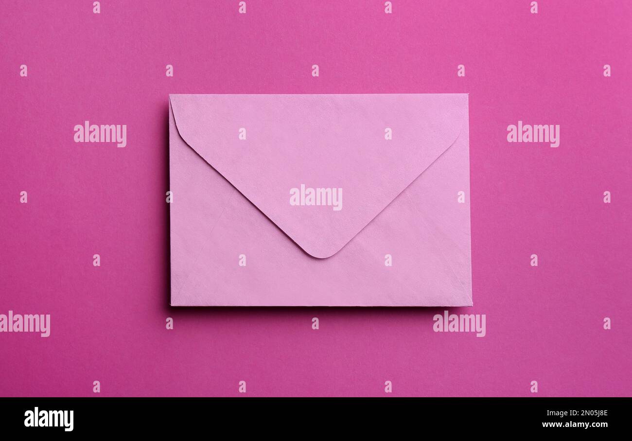Pink paper envelope on purple background, top view Stock Photo - Alamy