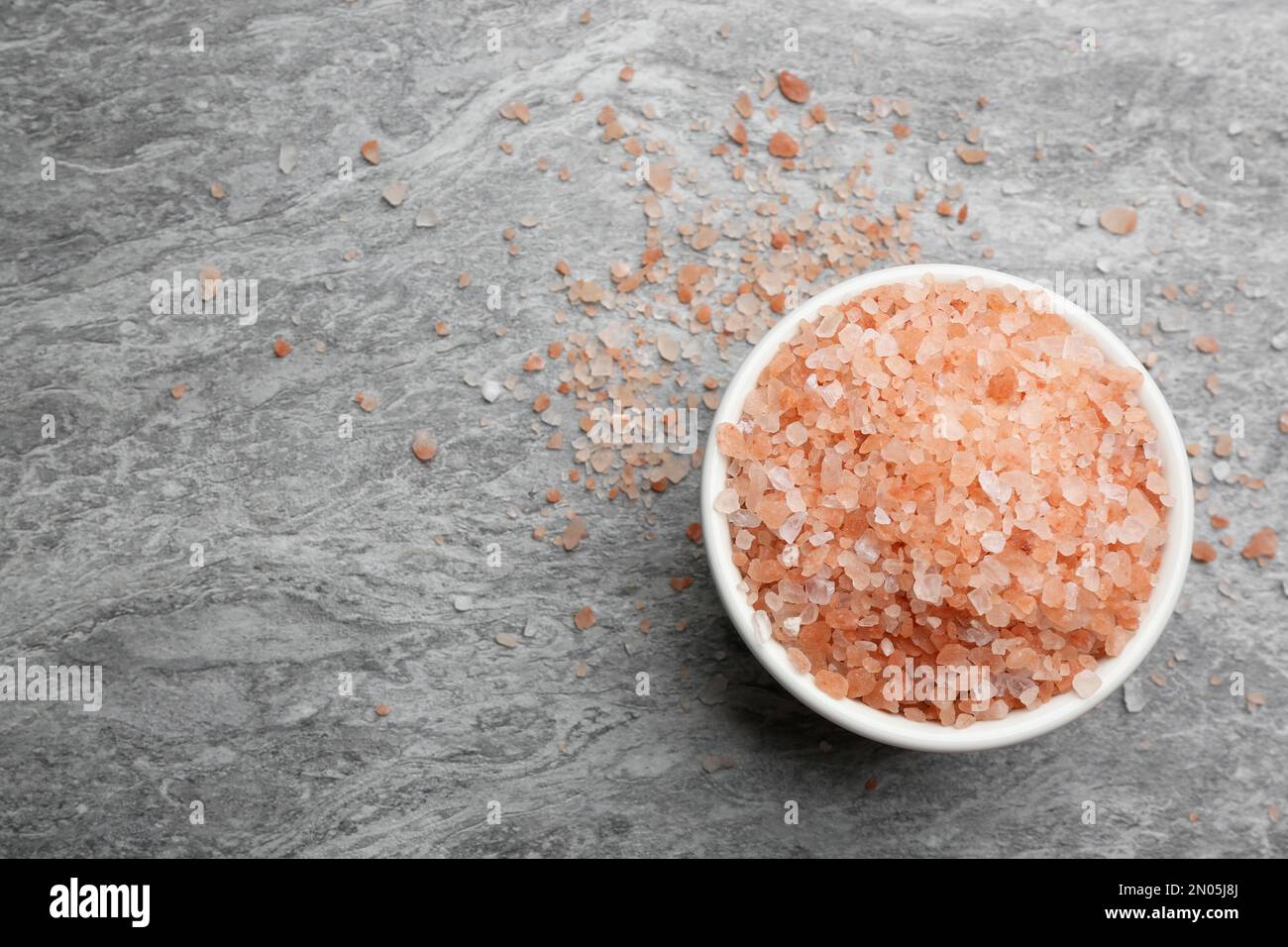 Pink himalayan salt on grey table, top view. Space for text Stock Photo ...