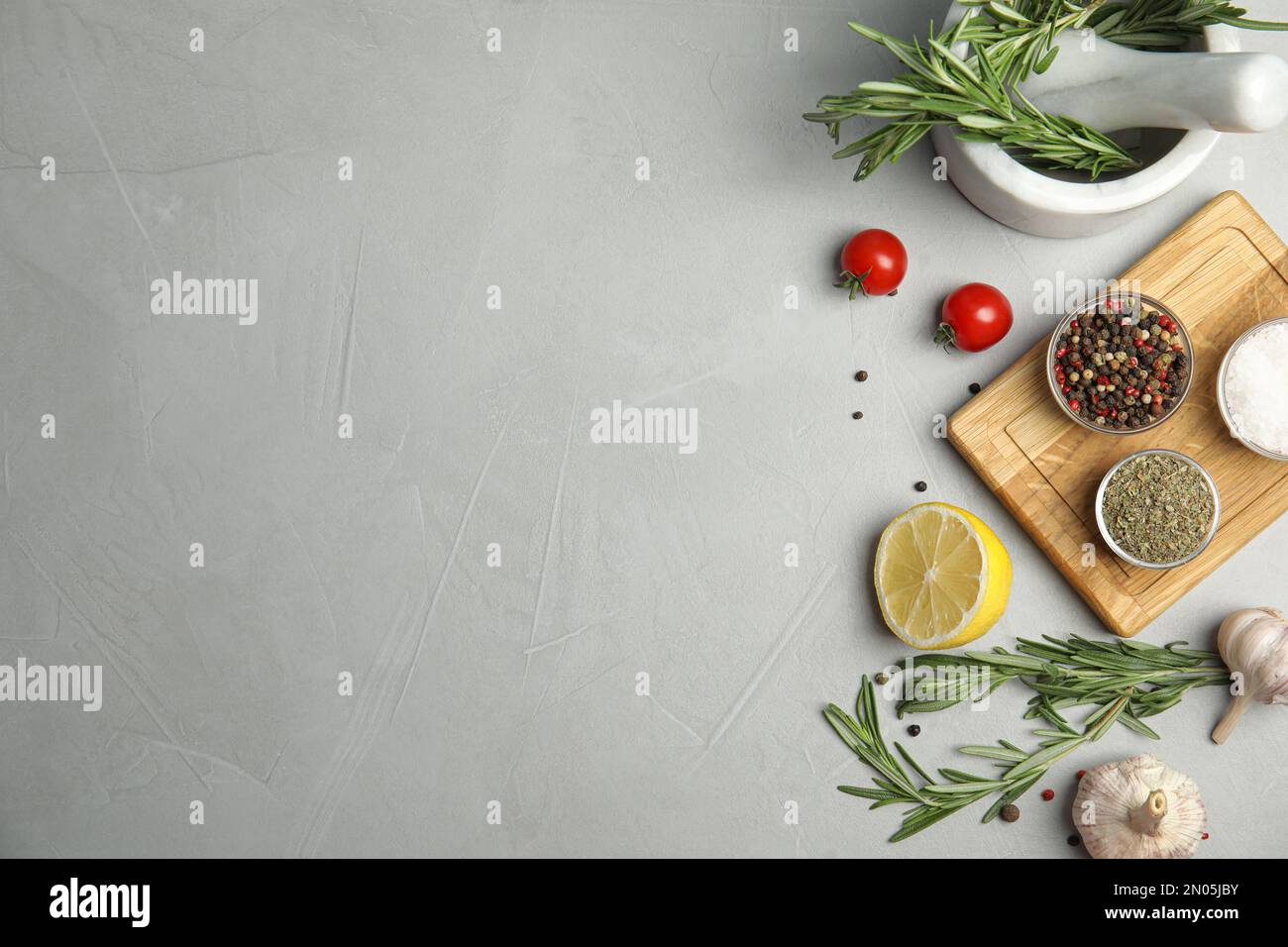 Flat lay composition with ingredients for cooking on grey table. Space ...