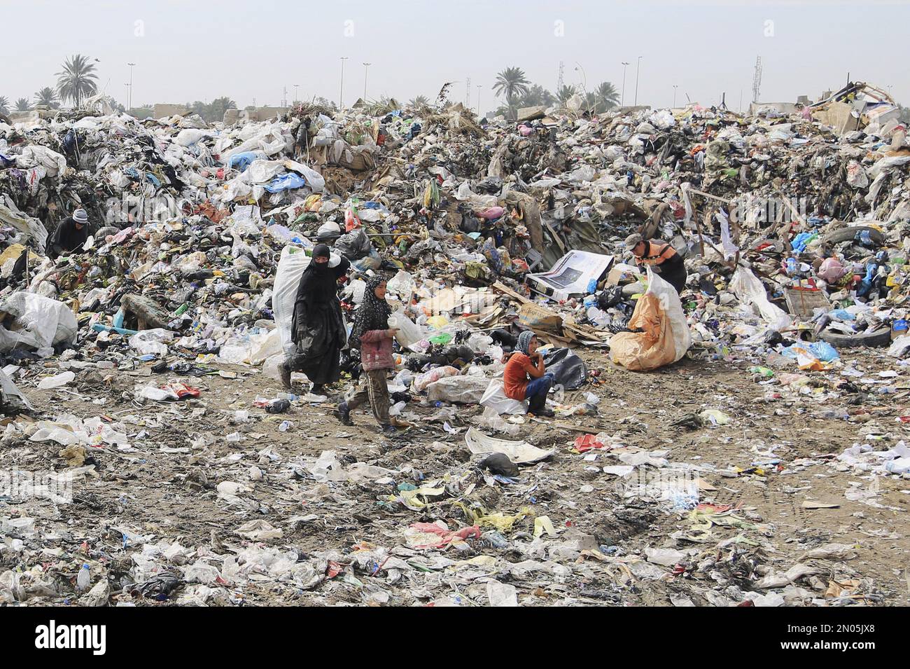 Iraqis search for recyclables on a garbage dump in Baghdad, Iraq ...