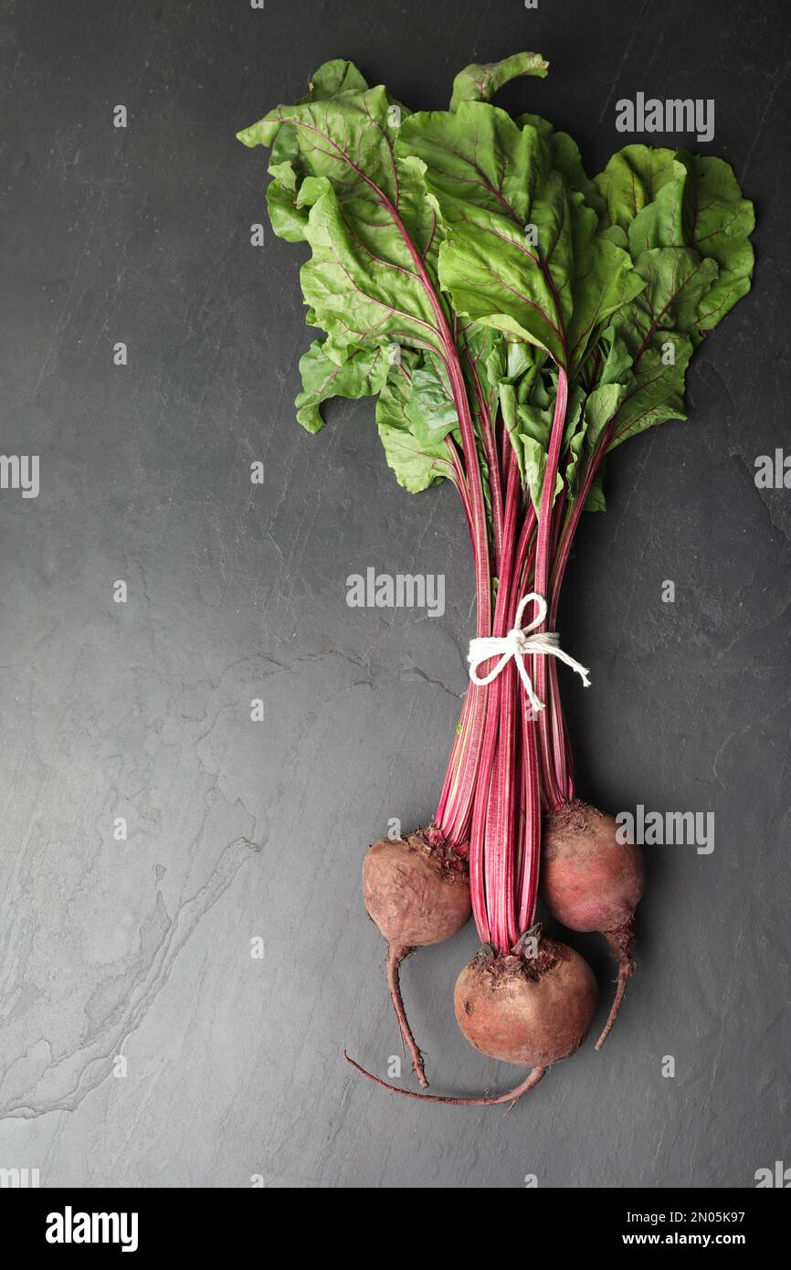 Raw ripe beets on black slate table, top view Stock Photo - Alamy