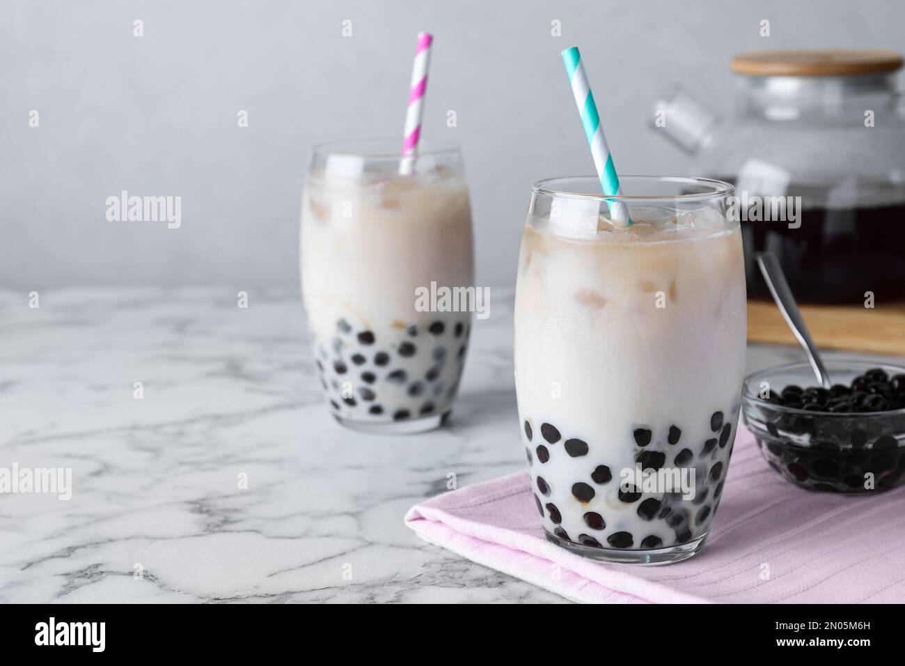 Bubble milk tea with tapioca balls on white marble table. Space for ...