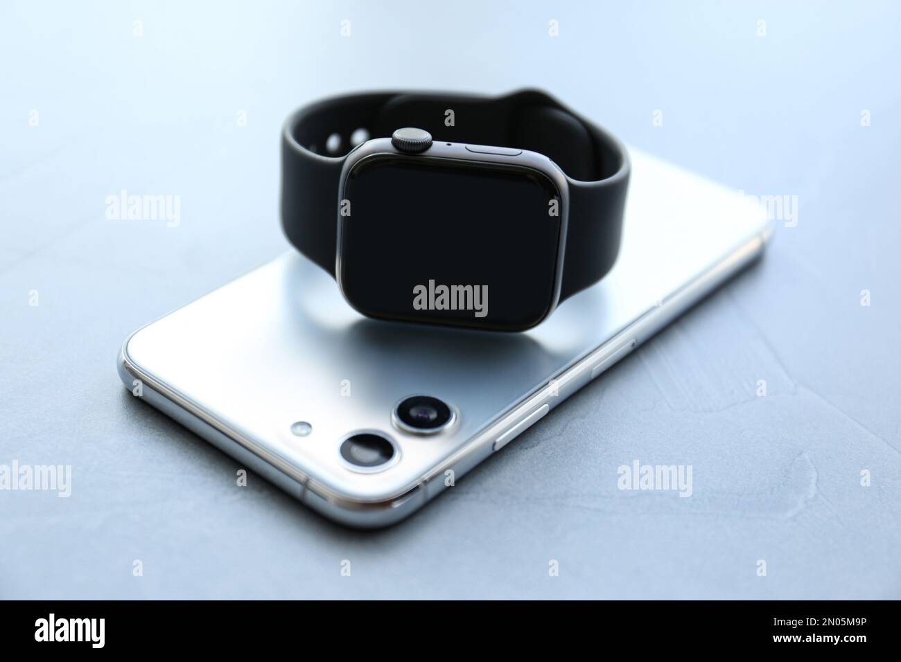 Stylish smart watch and phone on grey stone table, closeup Stock Photo ...