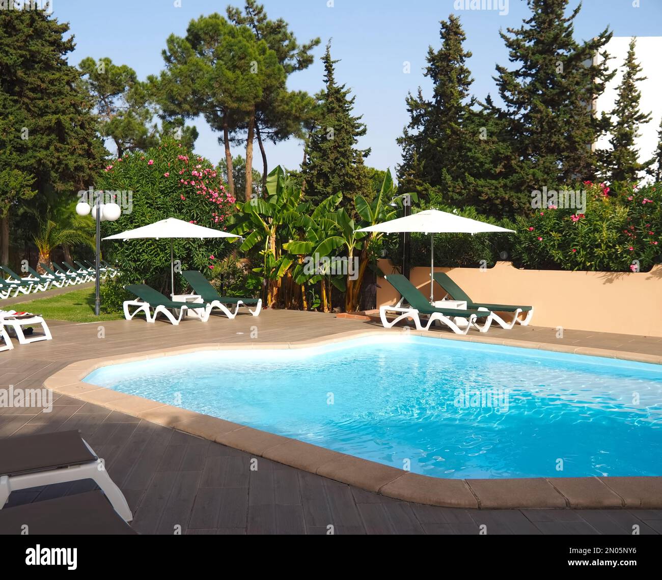 Typical hotel pool with sunbeds in Algarve Portugal Stock Photo - Alamy