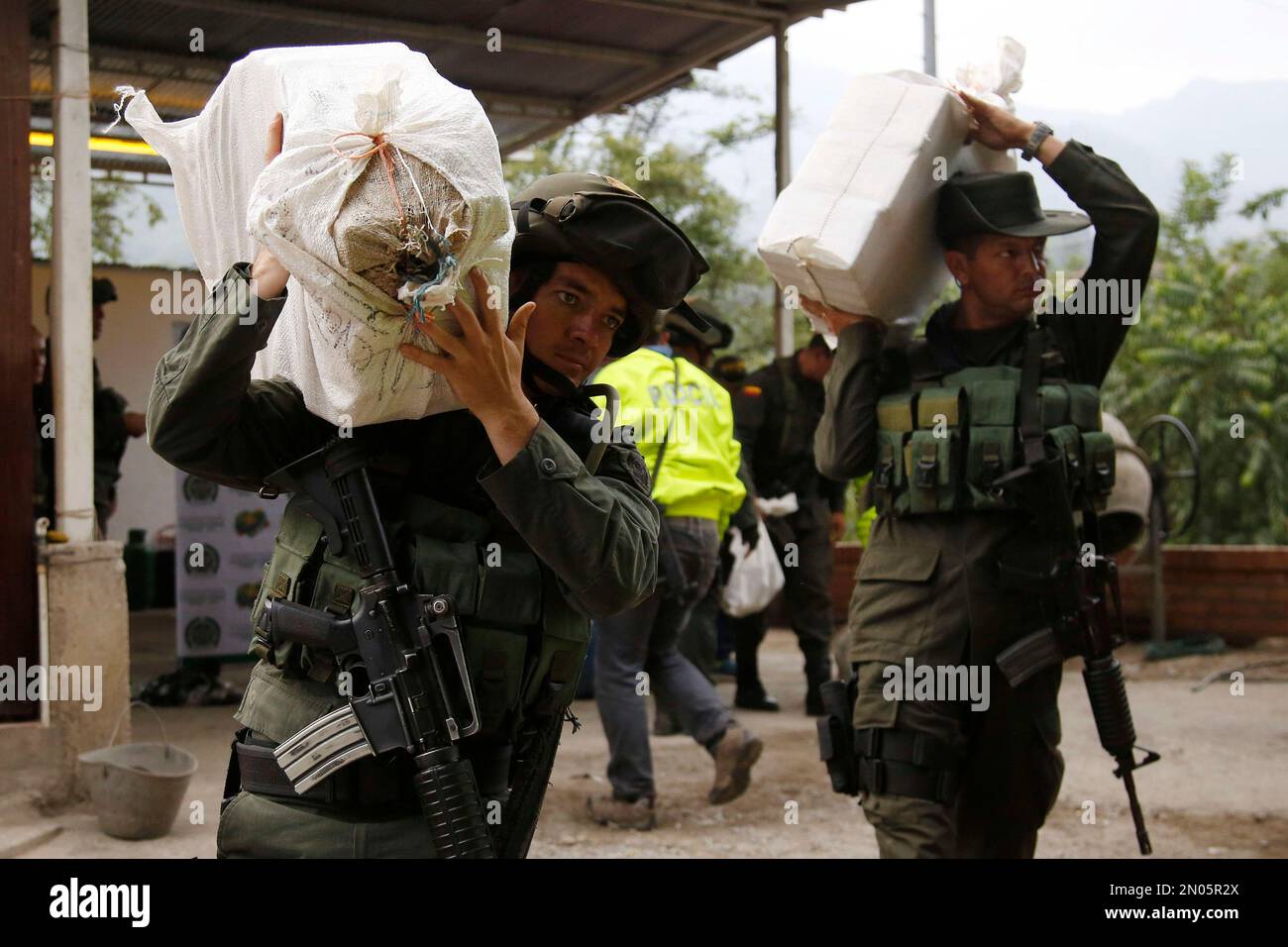 Counter narcotics police carry bags containing cocaine seized in ...