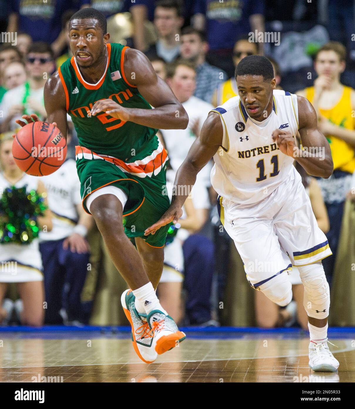 Miami’s Davon Reed (5) drives downcourt next to Notre Dame’s Demetrius ...