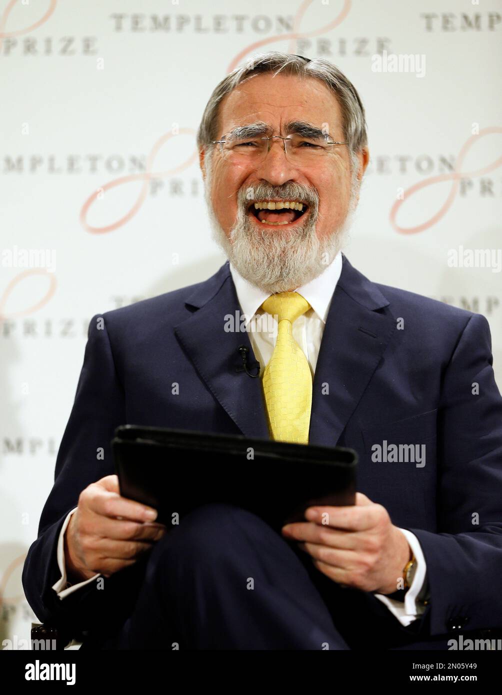 Rabbi Lord Jonathan Sacks laughs during a press conference to announce ...