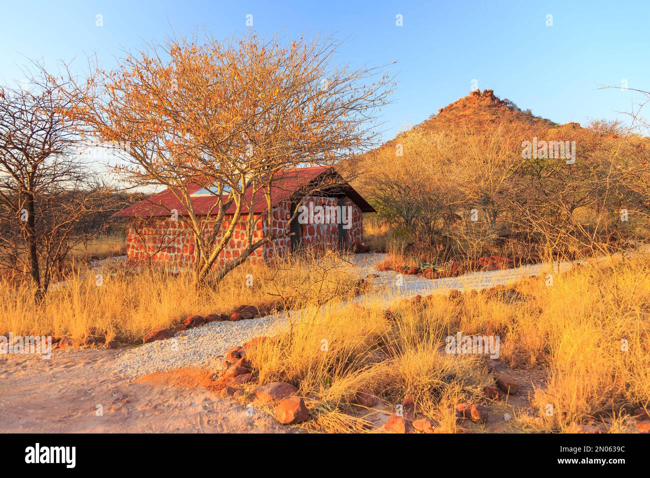 Red brick outbuilding at the Waterberg Plateau Campsite. Mountain in ...