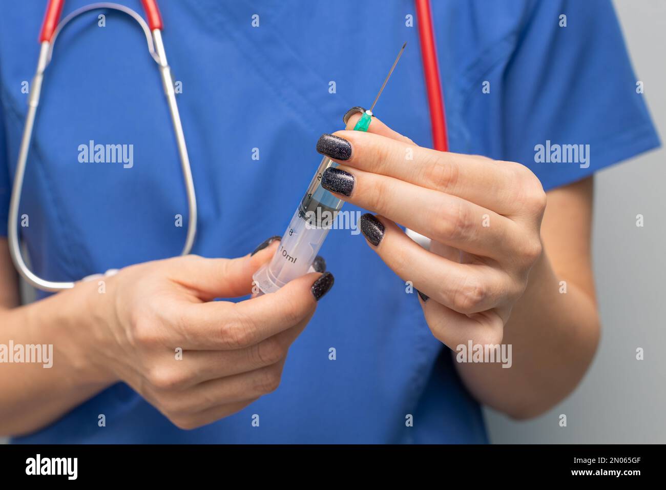 doctor holding a syringe with medicine in his hand. doctor holding a ...