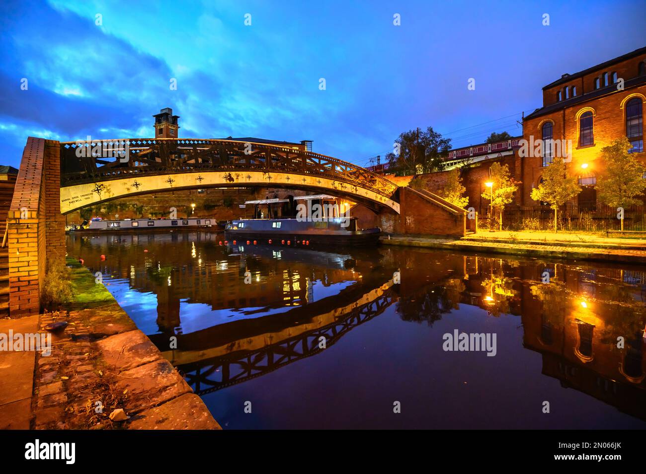 Reflection of footbridge in Rochdale canal passing through Manchester City, UK Stock Photo - Alamy