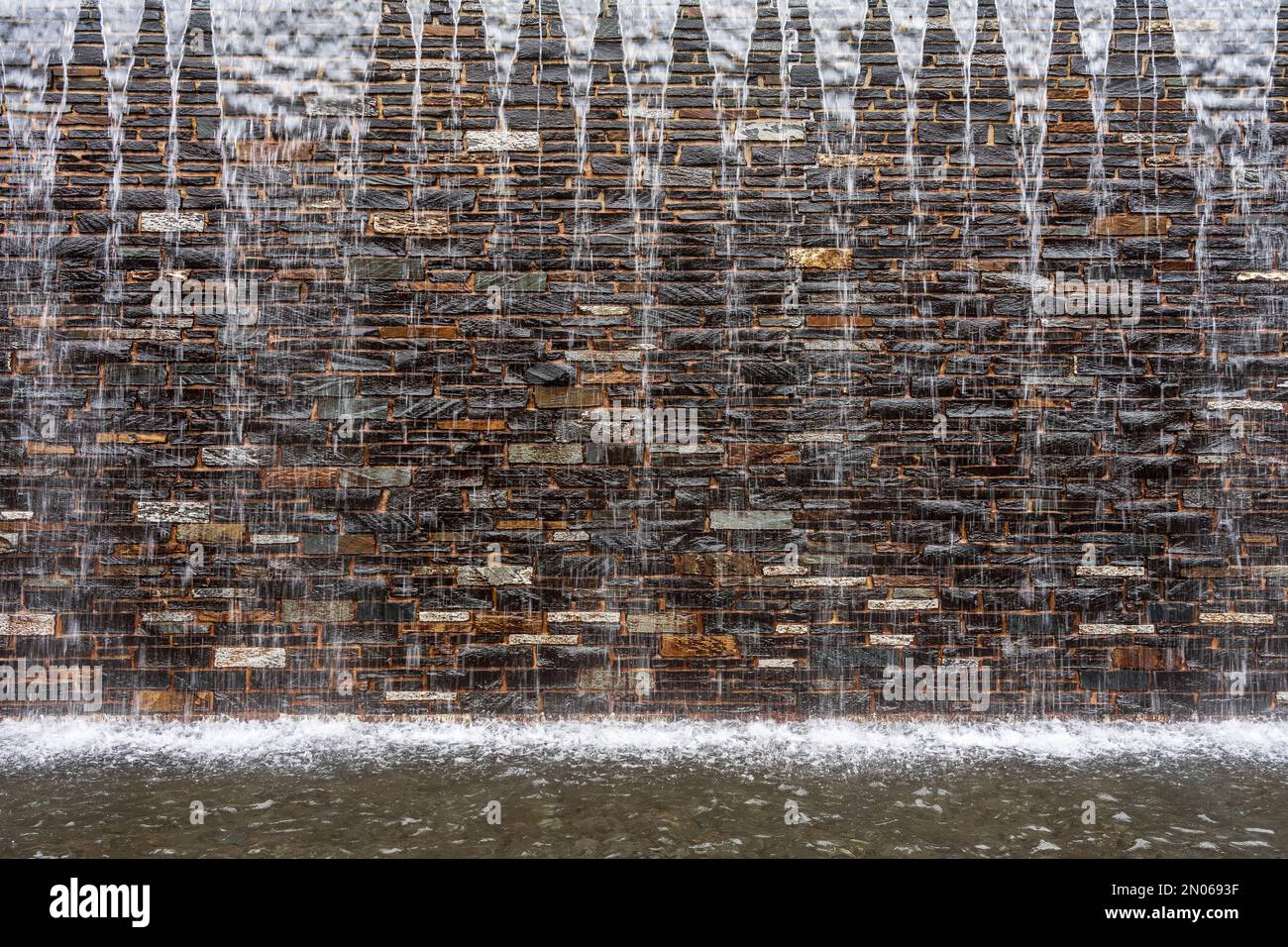 Stone wall and water stream. Background Stock Photo - Alamy
