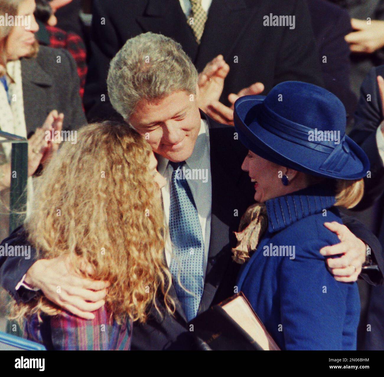 President Bill Clinton hugs daughter Chelsea, left, and wife Hillary ...
