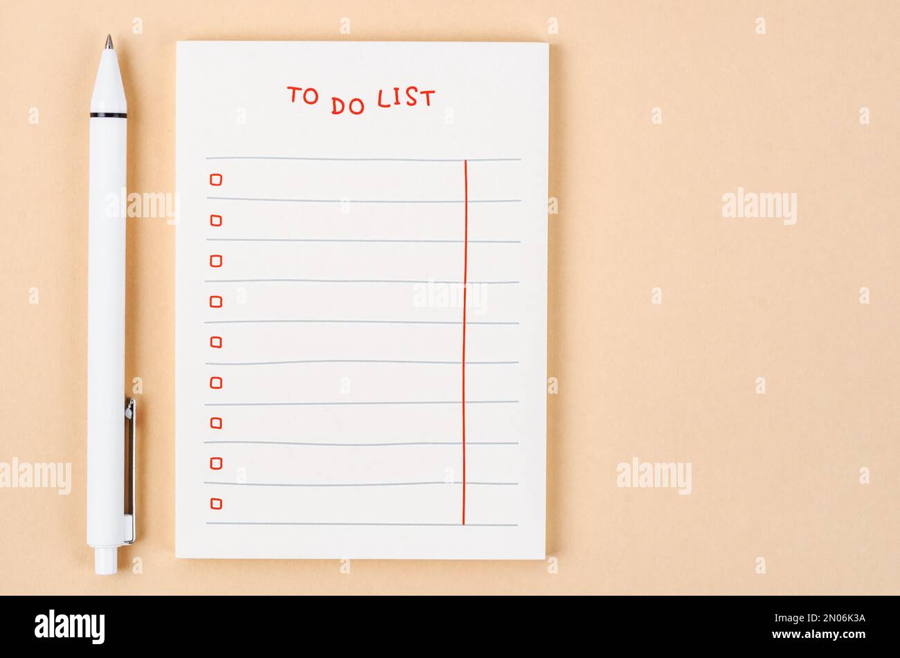Blank To Do List on yellow colour background. Empty schedule and a pen ...