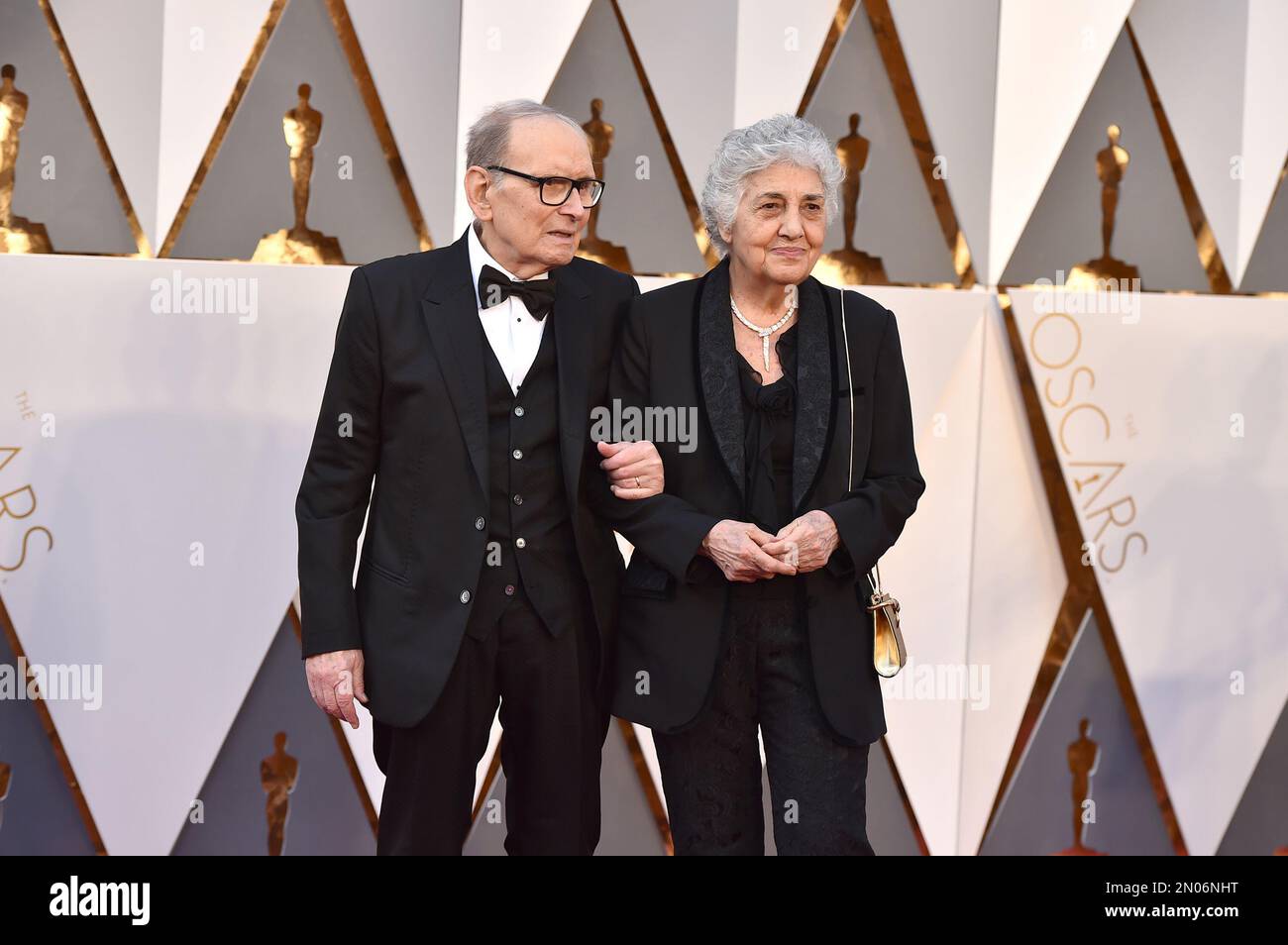 Ennio Morricone, left, and Maria Travia arrive at the Oscars on Sunday ...