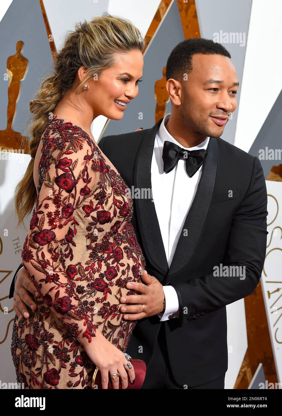 Christine Teigen, left, and John Legend arrive at the Oscars on Sunday ...