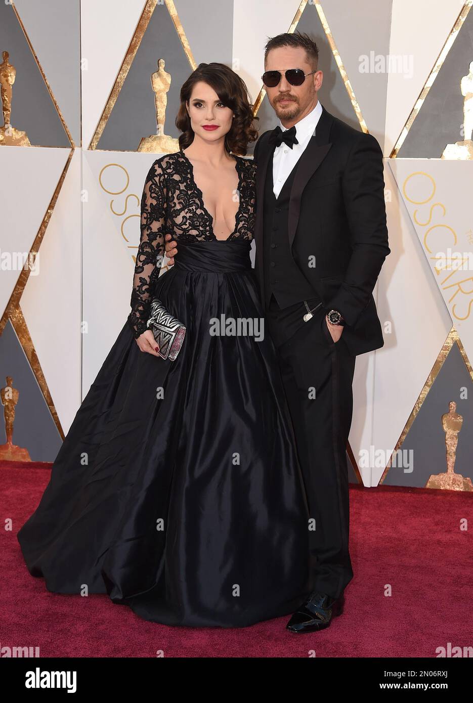 Charlotte Riley, left, and Tom Hardy arrive at the Oscars on Sunday ...