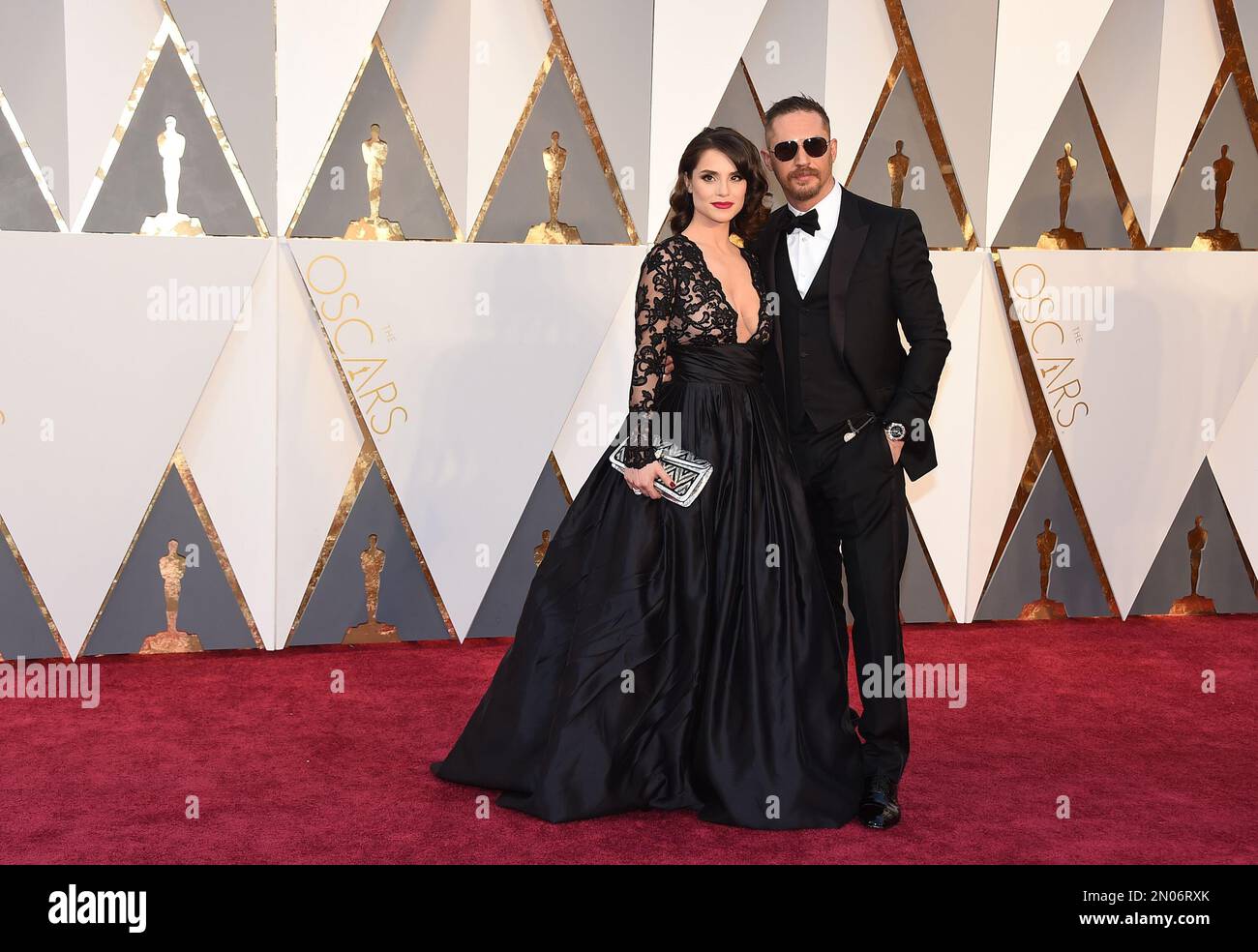 Charlotte Riley, left, and Tom Hardy arrive at the Oscars on Sunday ...