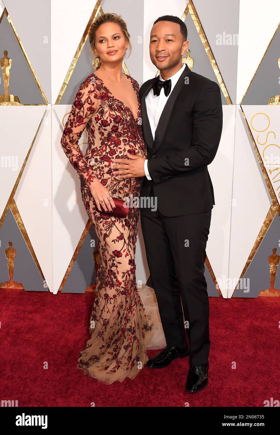 Christine Teigen, left, and John Legend arrive at the Oscars on Sunday ...