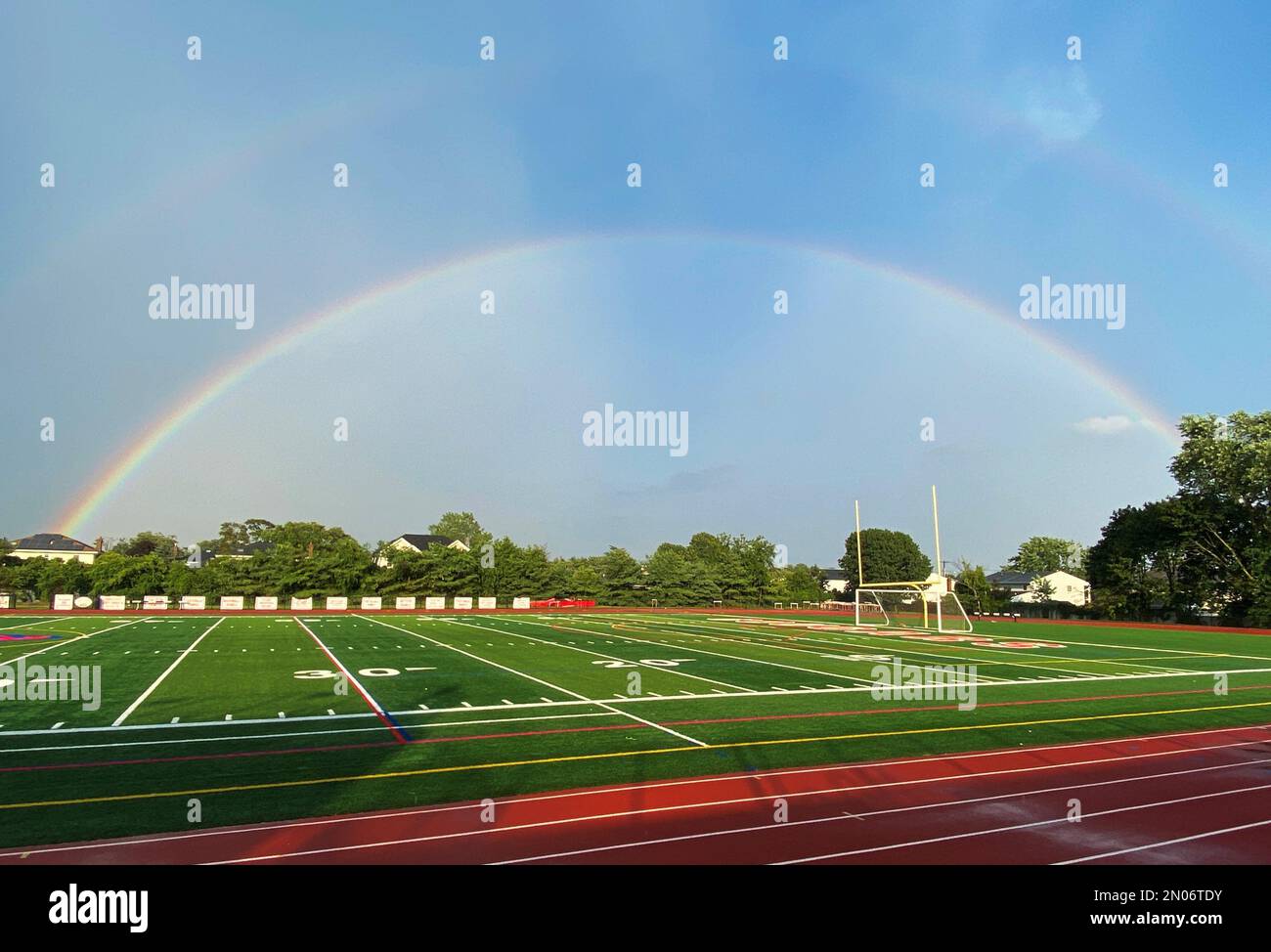 A double rainbow forms over an athletic field after a summer rainstorm ...