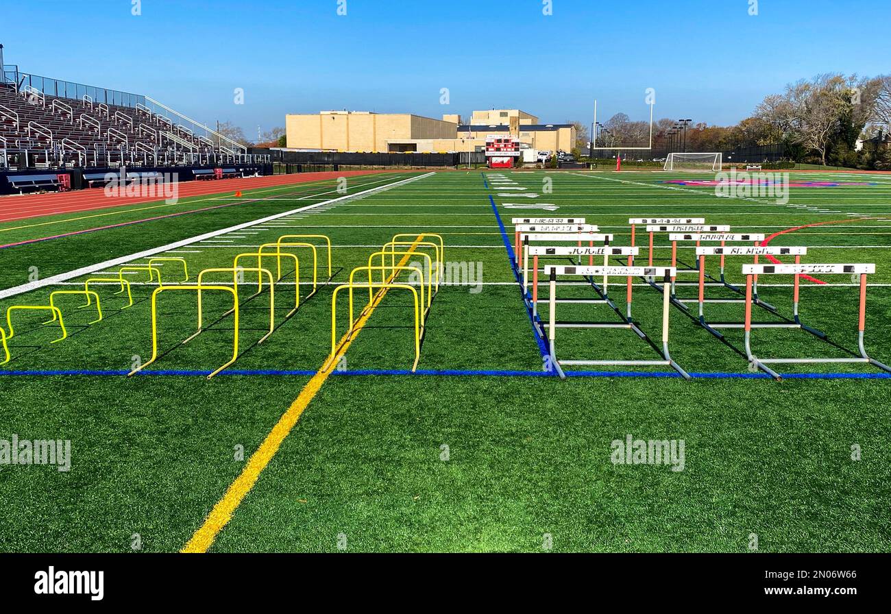 Different kinds of hurdles set up on a turf field for stength and agility pratice with no people ...