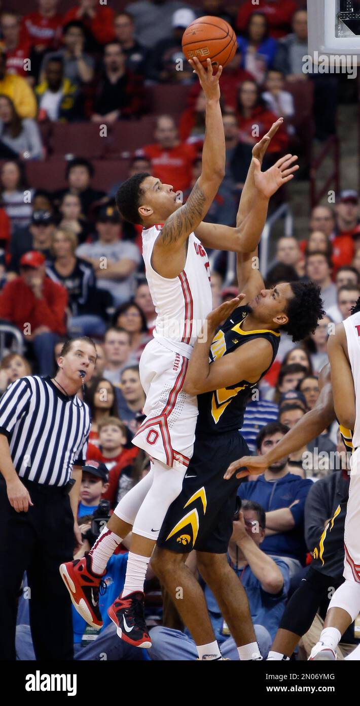 Ohio State's Marc Loving, left, shoots over Iowa's Dom Uhl during the ...