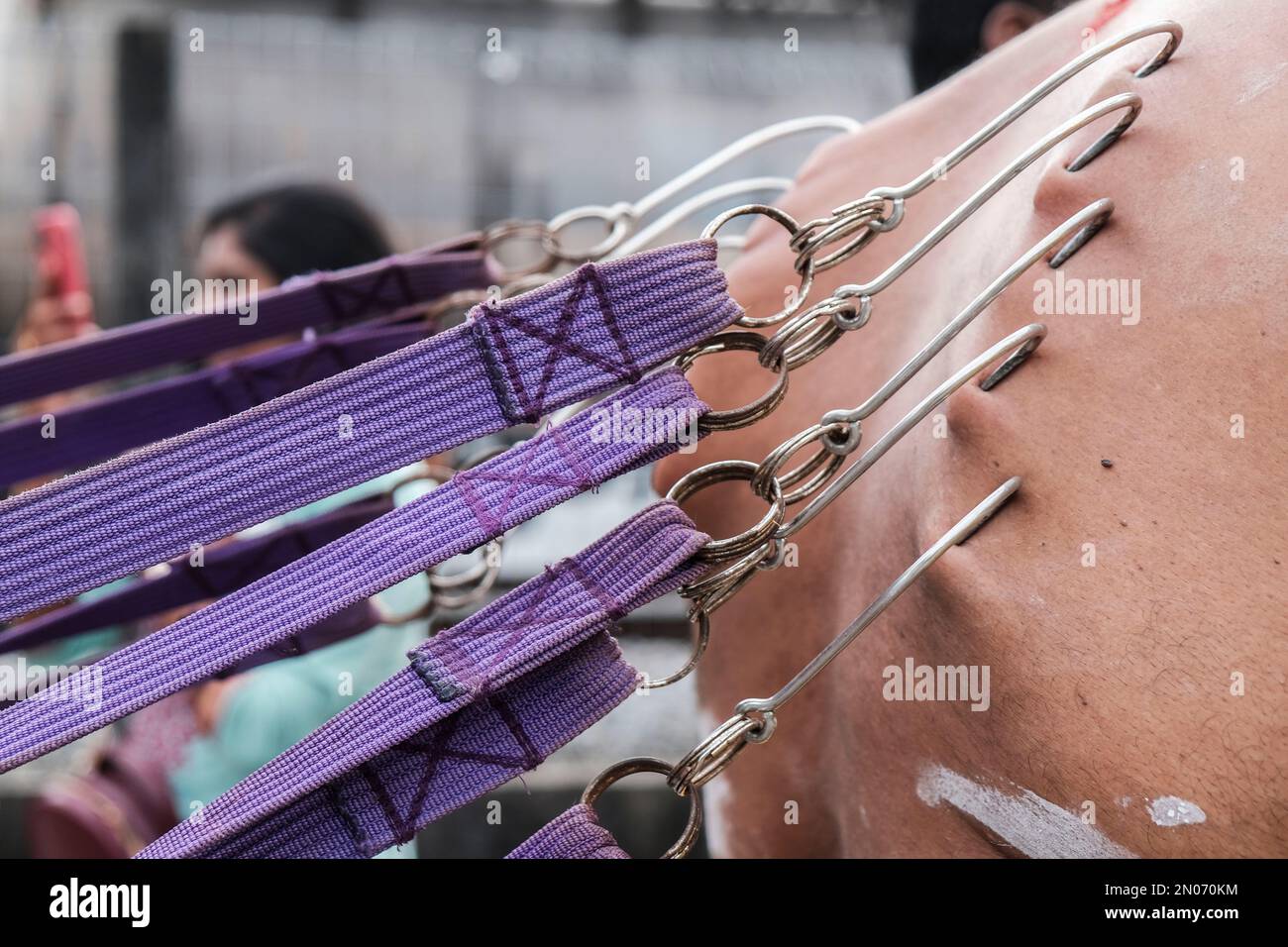 A Hindu devotee seen having a hooks hung on his back during the ...