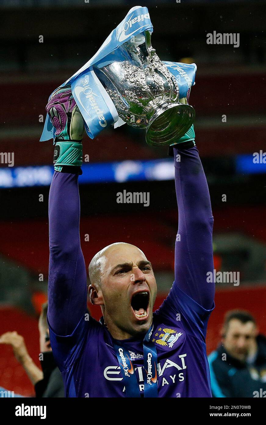 Manchester City's goalkeeper Willy Caballero raises the trophy after ...