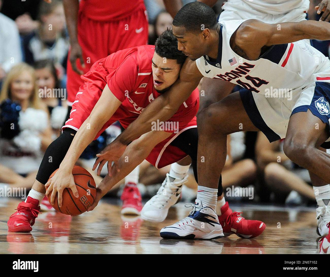 Houston’s Rob Gray, Jr., left, keeps the ball from Connecticut's Rodney ...