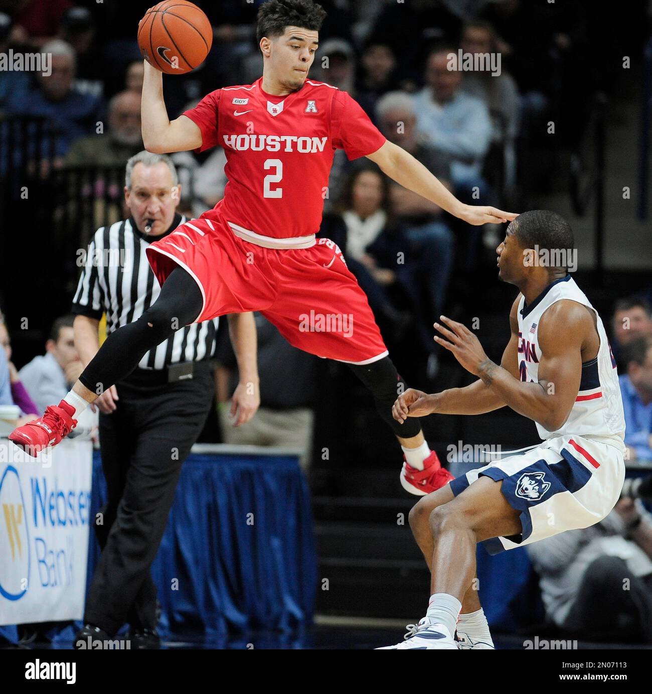 Houston’s Rob Gray, Jr., left, looks to pass around Connecticut's ...