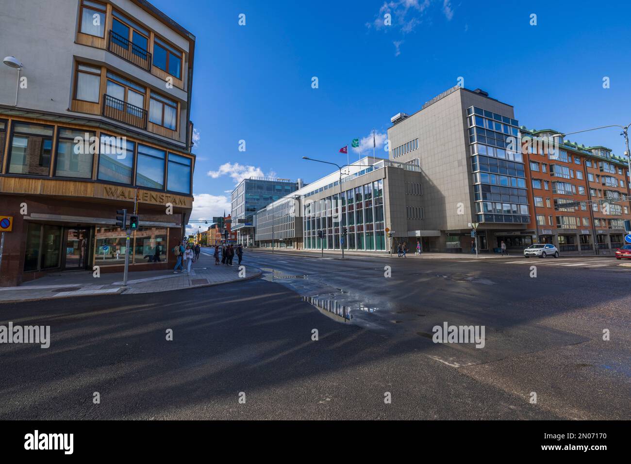 Beautiful cityscape view on bright spring day. Wet asphalt roads after ...