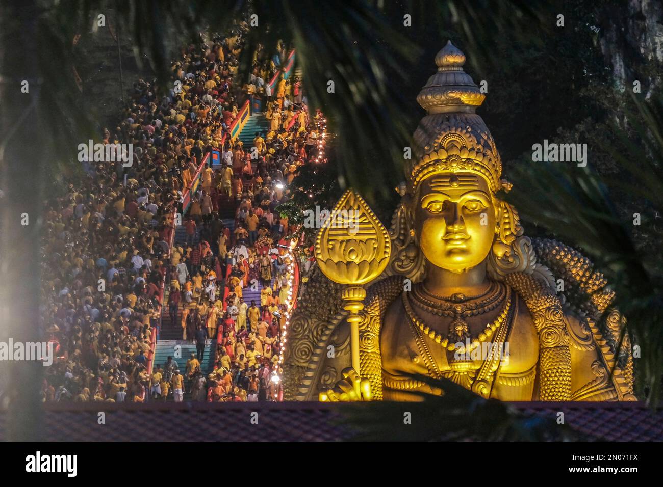 Thousands of Hindu devotees seen on a stair behind the giant Murugan ...