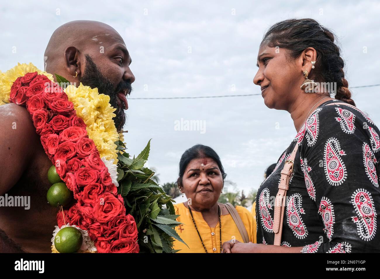 A Hindu devotee seen with his family while in trance during the ...