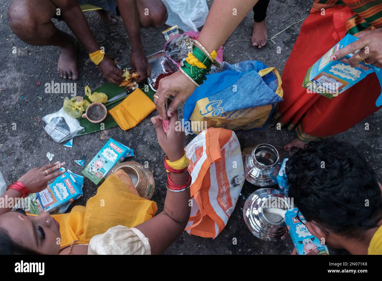Batu Caves, Malaysia. 05th Feb, 2023. A family of Hindu devotee prepare ...